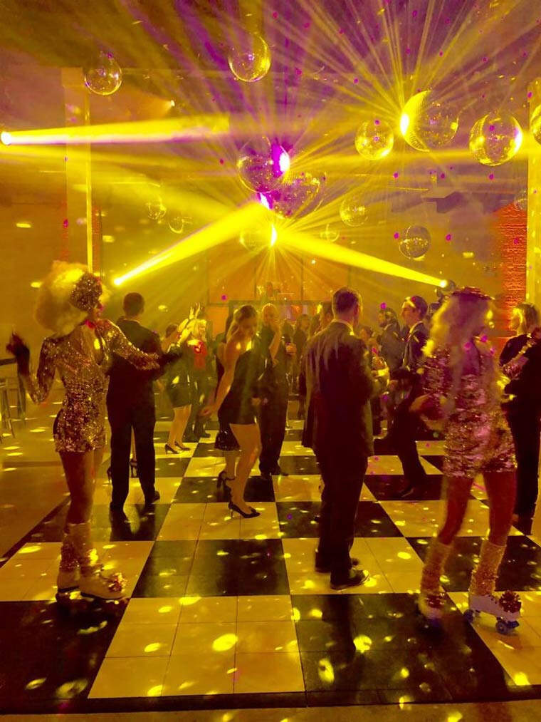 Disco-themed New Year’s house party with disco ball, neon lights and ...